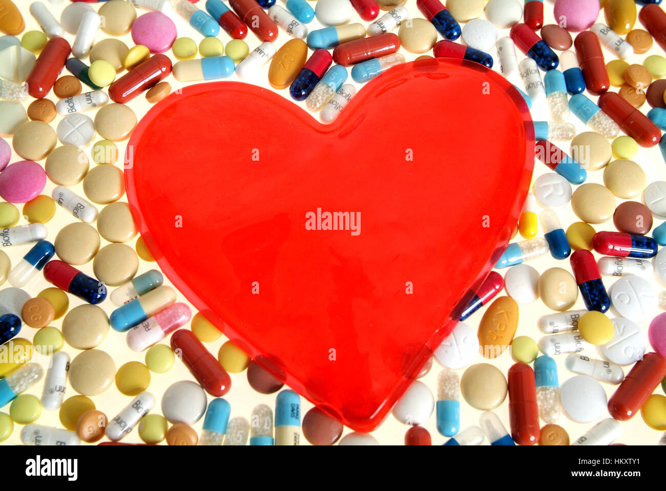 Heart and tablets, symbolic for heart disease Stock Photo - Alamy