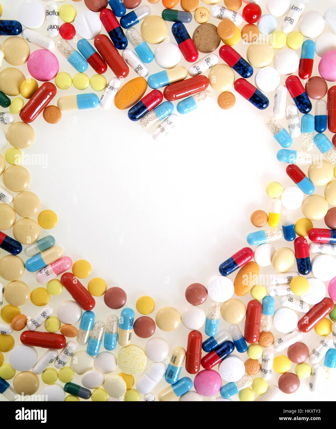 Heart and tablets, symbolic for heart disease Stock Photo - Alamy