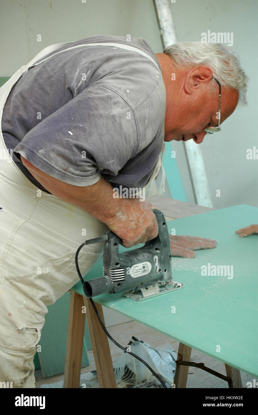 Senior working with jigsaw Stock Photo - Alamy
