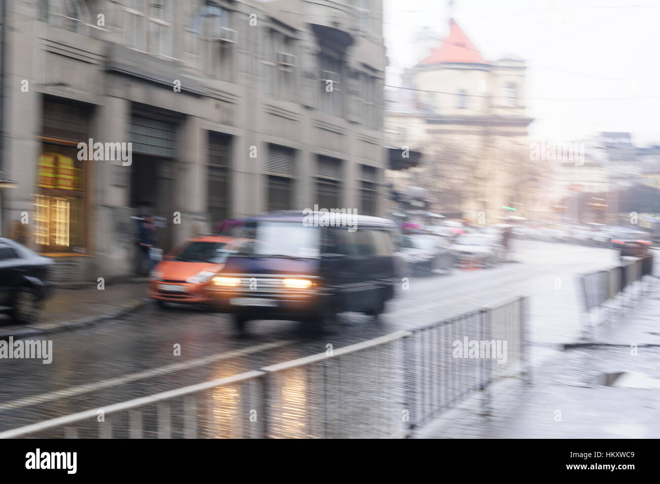 cars going down the street in the rain. blurred focus Stock Photo - Alamy