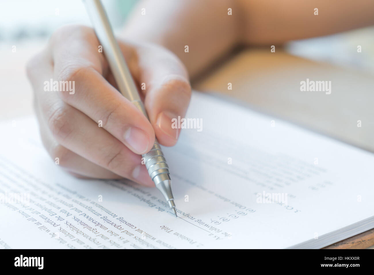 Hand with pen over application form Stock Photo - Alamy