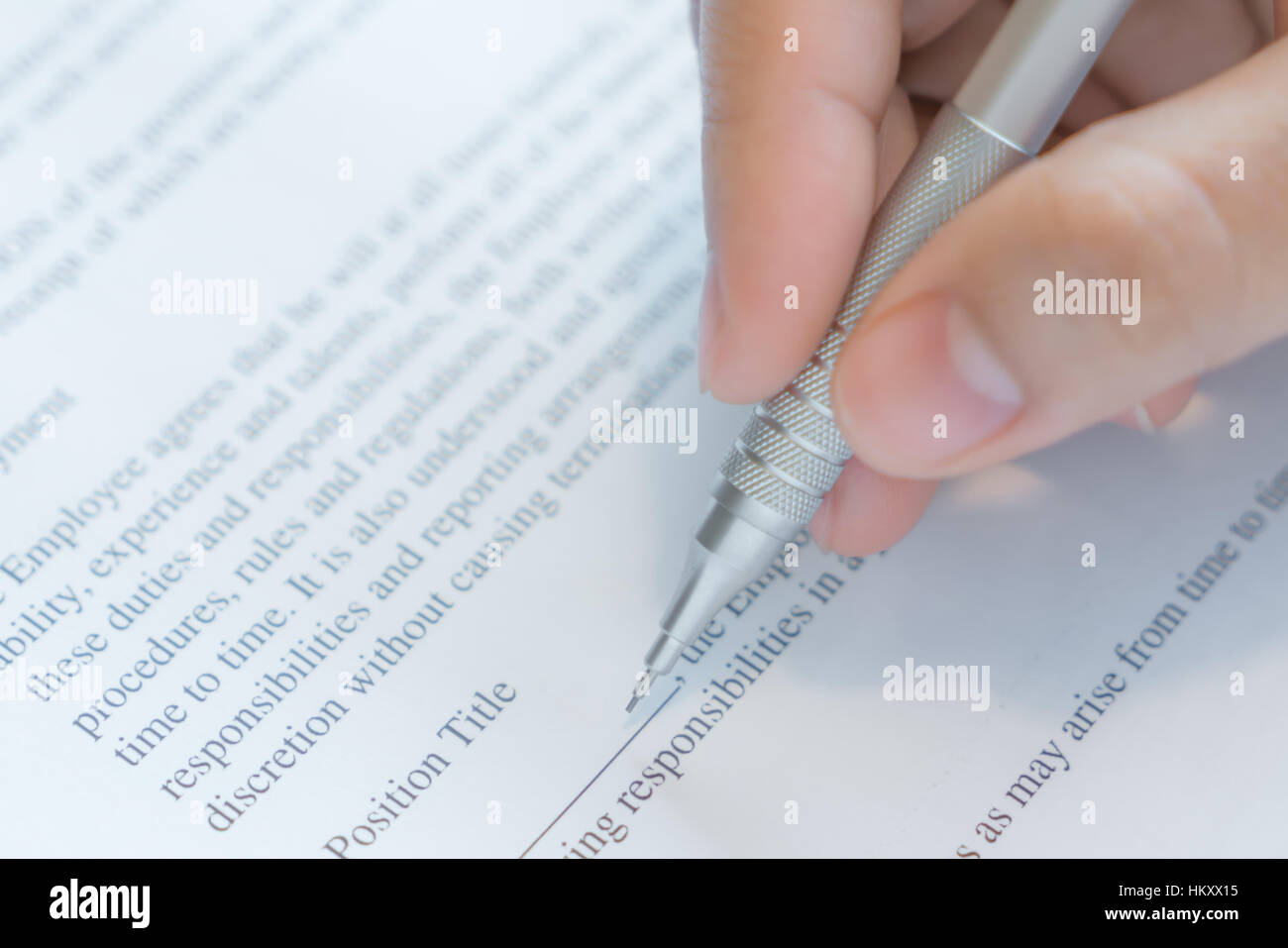 Hand with pen over application form Stock Photo - Alamy