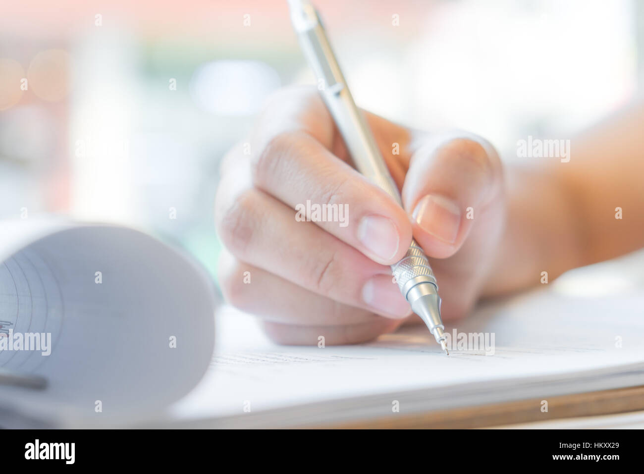 Hand with pen over application form Stock Photo - Alamy