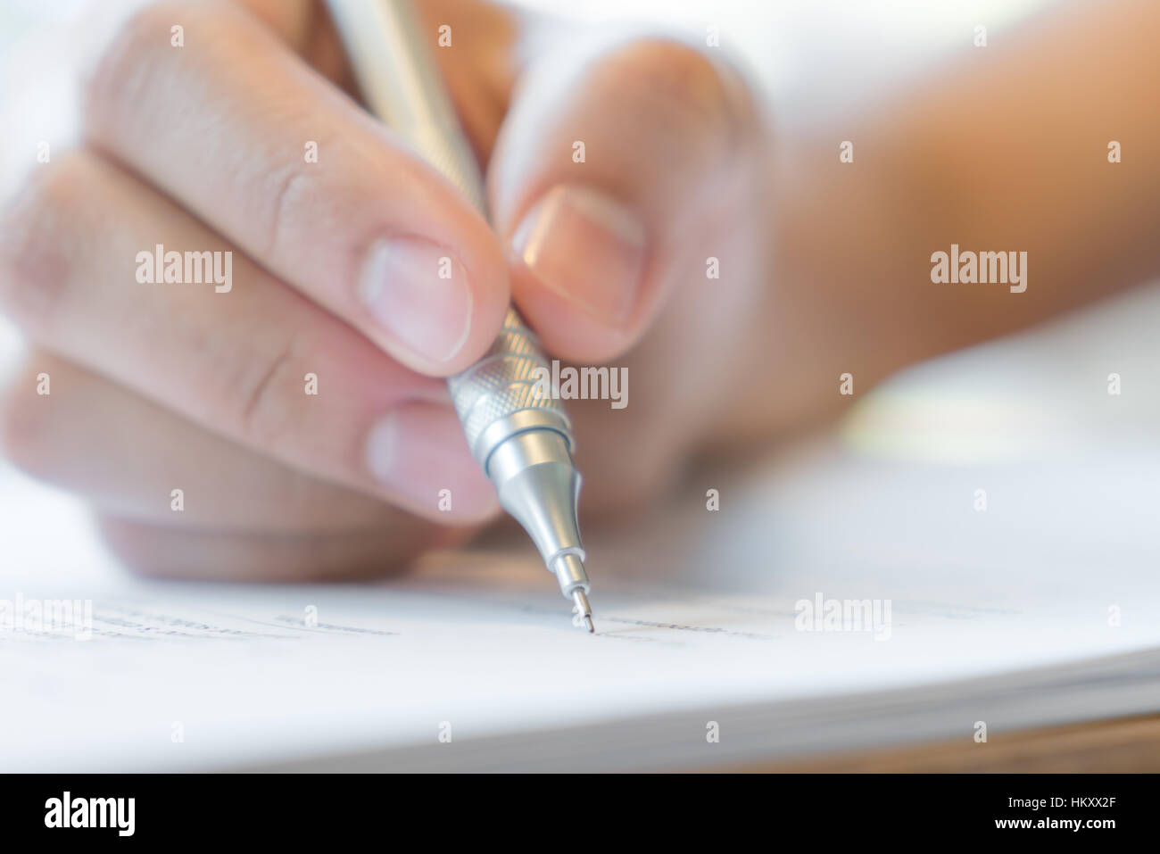 Hand with pen over application form Stock Photo - Alamy