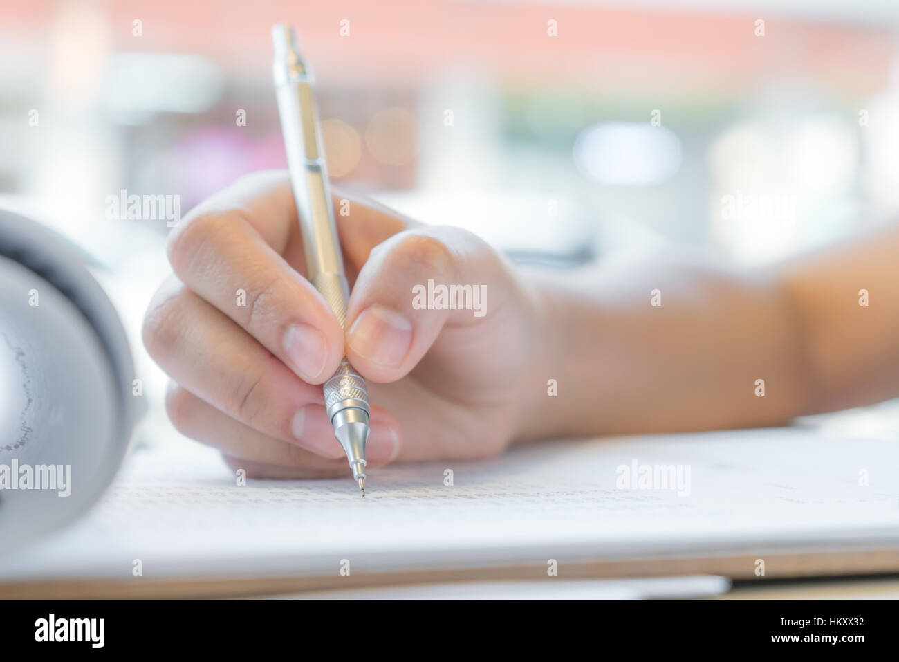 Hand with pen over application form Stock Photo - Alamy