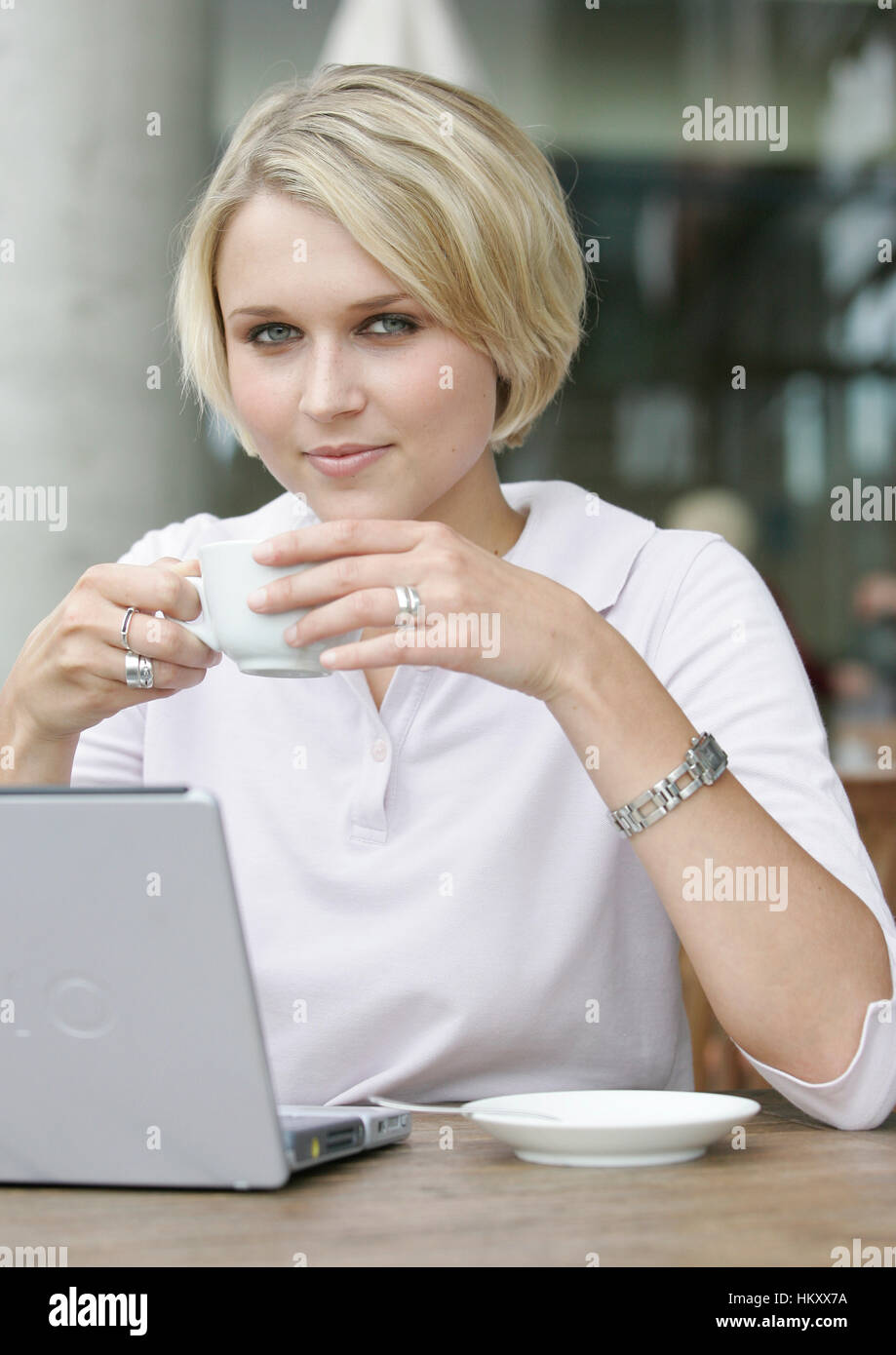 Business woman with laptop, drinking coffee Stock Photo - Alamy