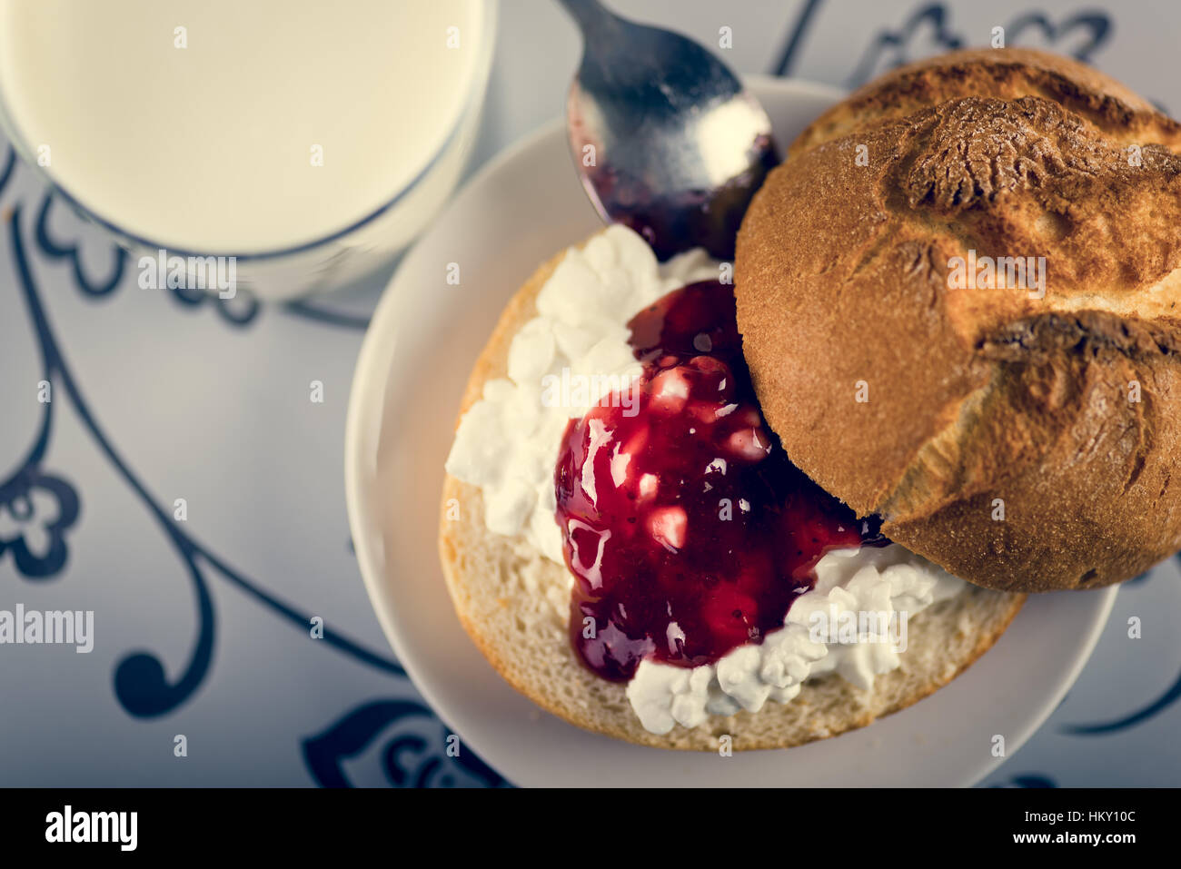 Glass of milk, fresh tasty sandwich make of cut roll, cottage cheese ...