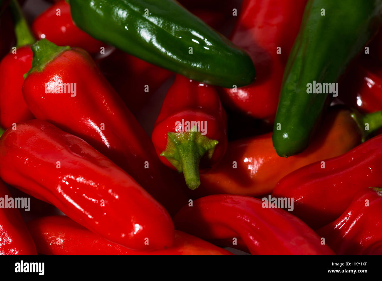 Whole red and green fresh chillies in close-up Stock Photo - Alamy