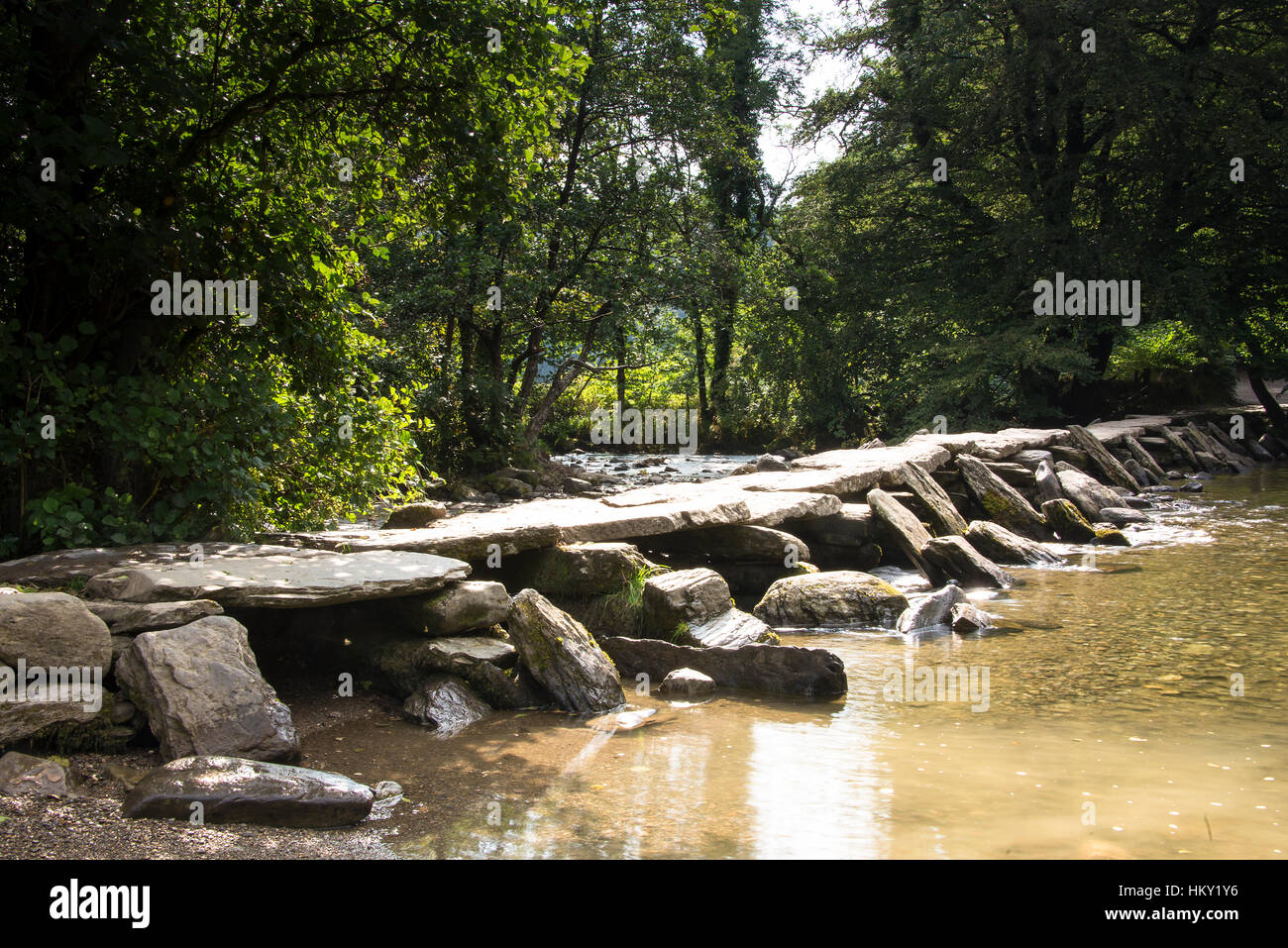 Clapper bridge over river in sunshine at Tarr Steps on Exmoor in ...