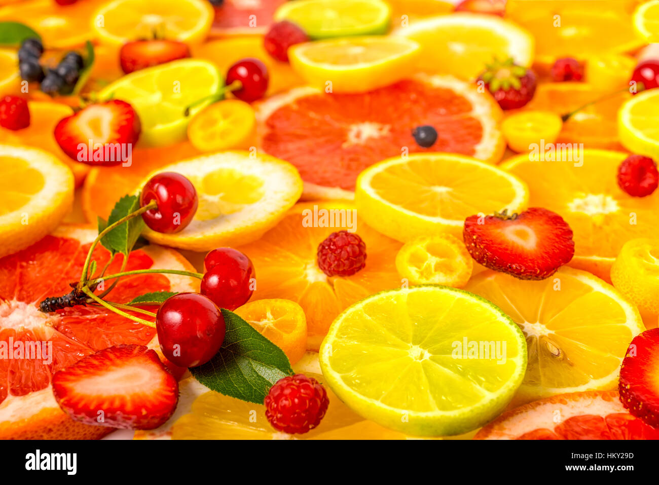 beautiful fresh sliced mixed citrus fruits as background with different ...