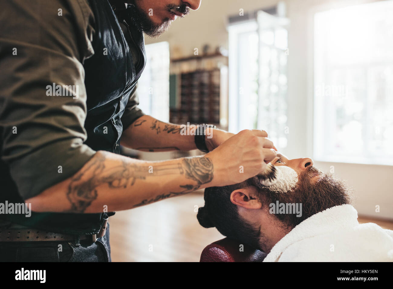Barber shaving man in barbershop hi-res stock photography and images ...