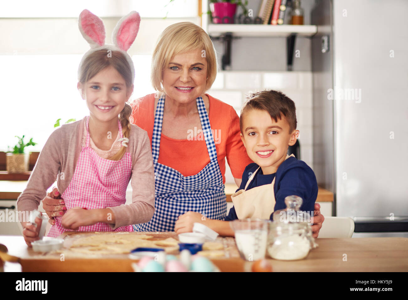 Portrait of family baking in kitchen interior Stock Photo - Alamy