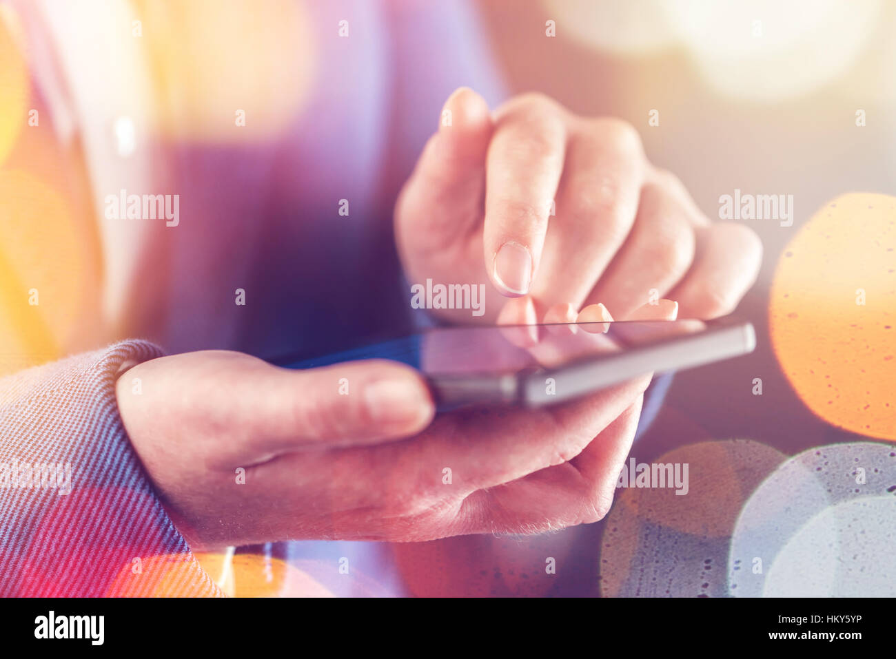 Female hands with mobile phone, finger on touchscreen Stock Photo - Alamy