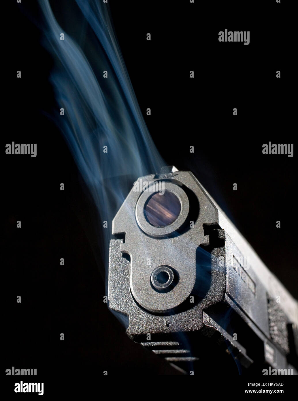 Handgun with a polymer frame that is smoking on the barrel end Stock ...