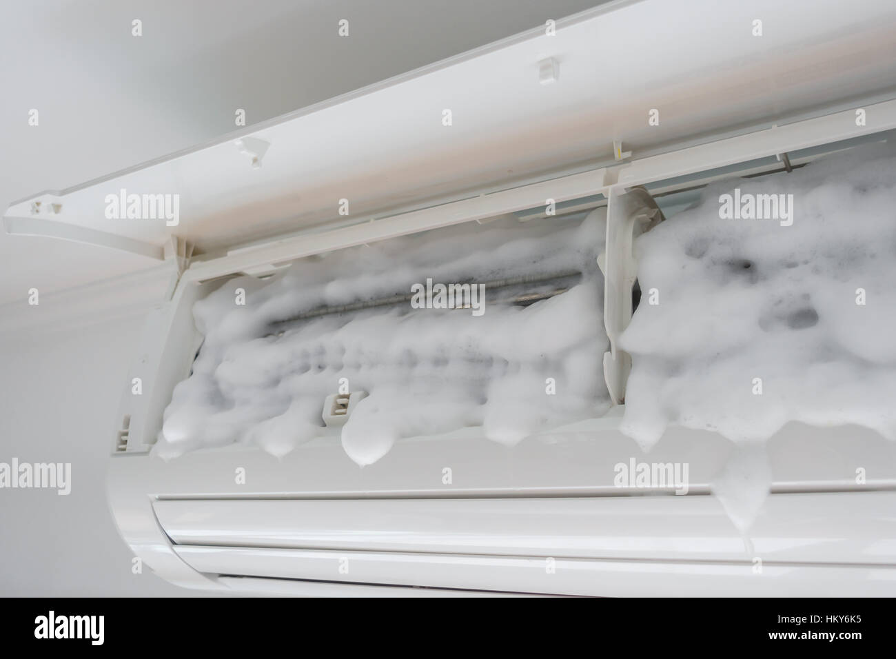 Air conditioner cleaning with washing foam Stock Photo - Alamy