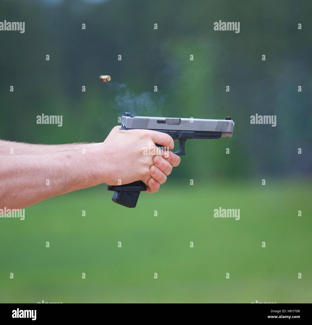 Semi auto handgun just after a shot has been taken Stock Photo - Alamy