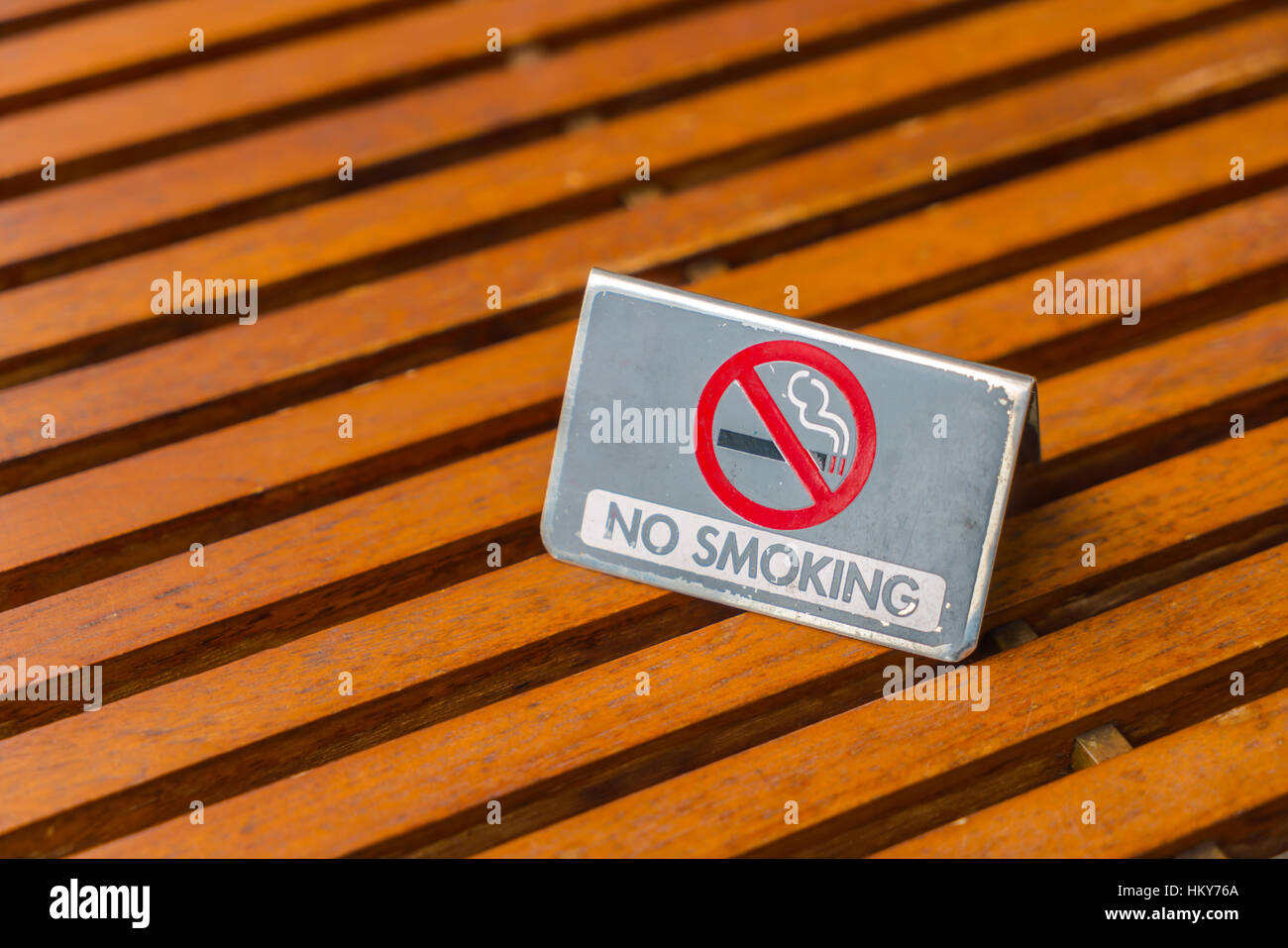 NO Smoking sign on wood table Stock Photo - Alamy