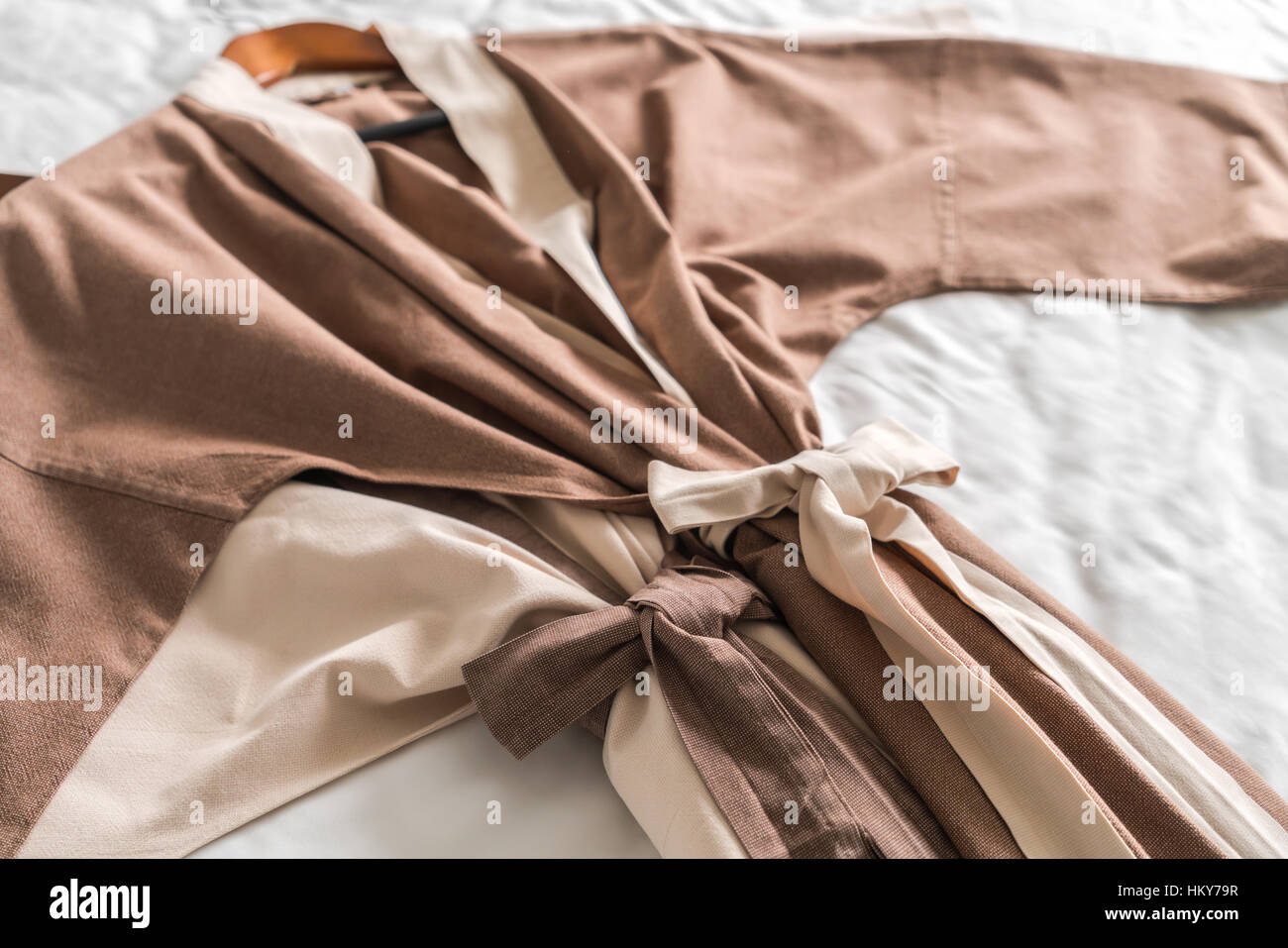 Clean bathrobe on bed Stock Photo - Alamy
