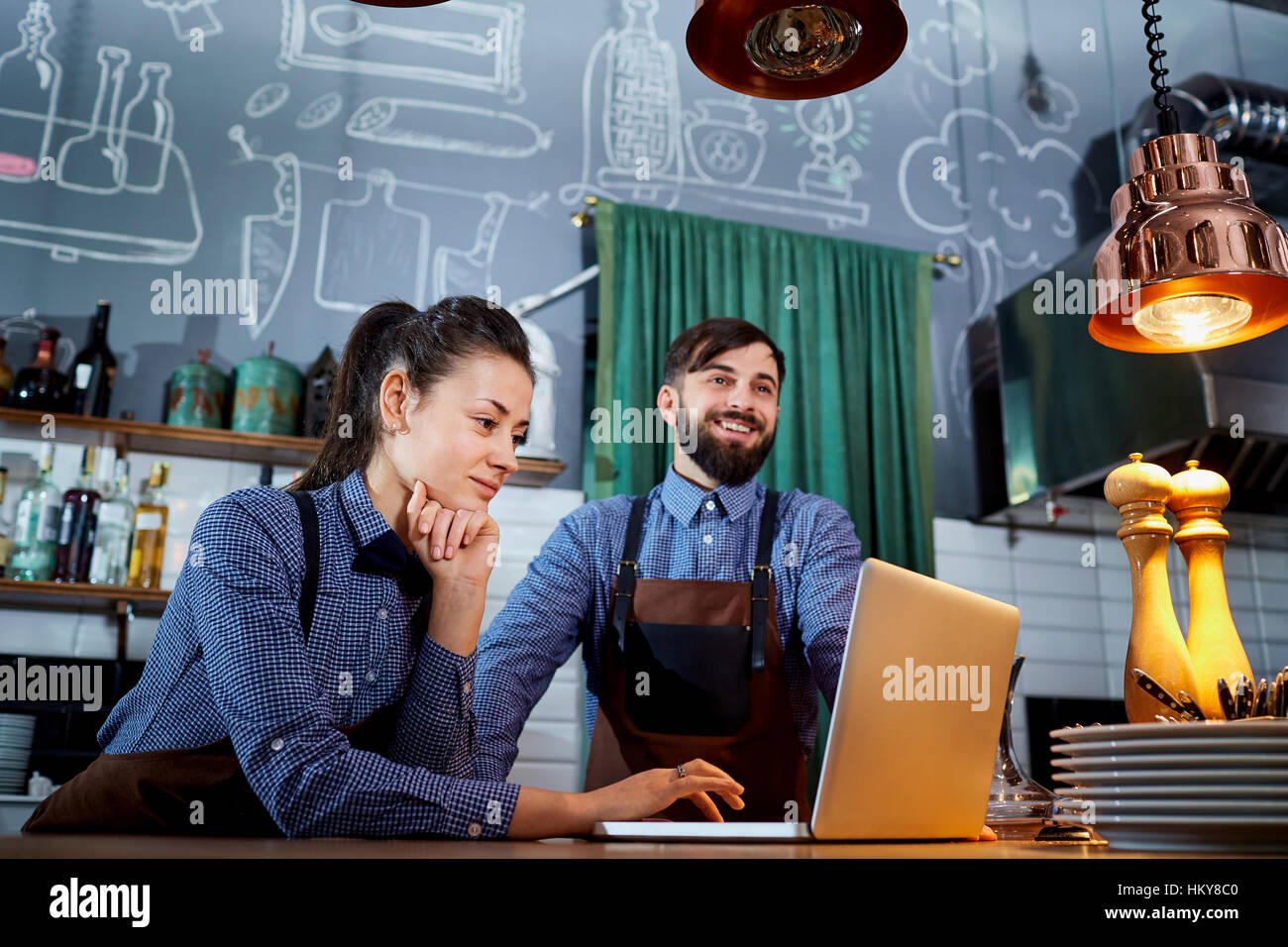 The bartender barista woman with a laptop at work in restaurant Stock ...