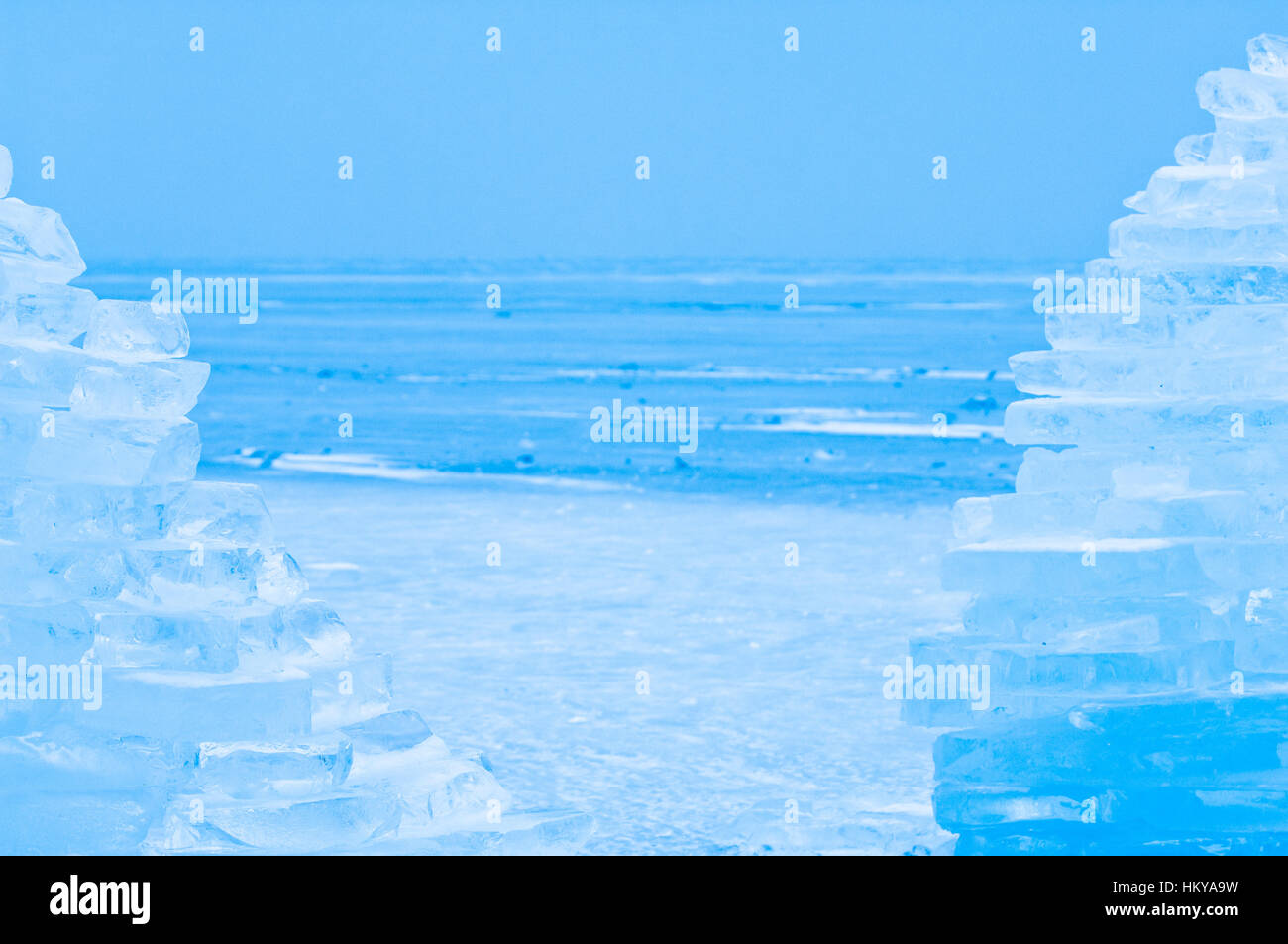 Winter scene at a frozen lake with ice-tower Stock Photo - Alamy