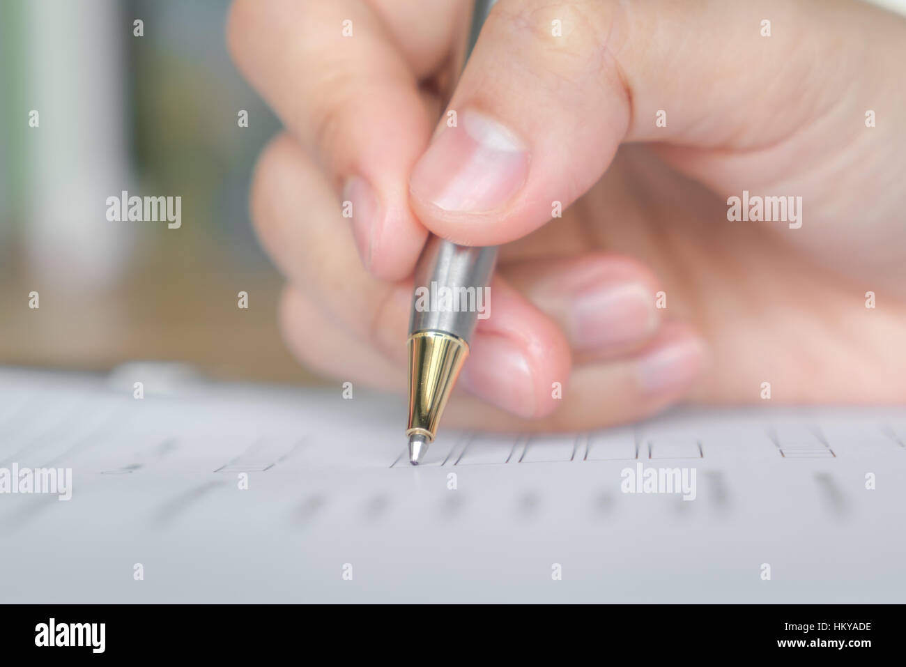 Hand with pen over application form Stock Photo - Alamy