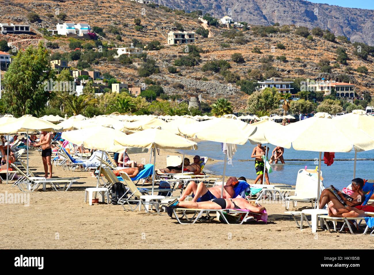 Tourists relaxing on the beach, Elounda, Crete, Greece, Europe Stock ...