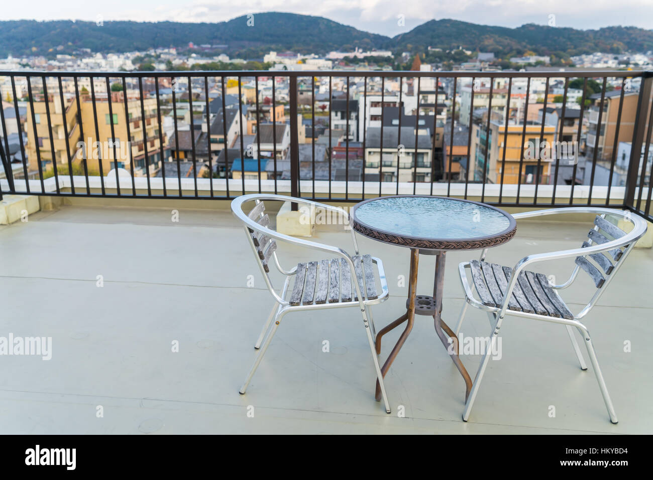 Table and chairs on roof top terrace exterior Stock Photo - Alamy
