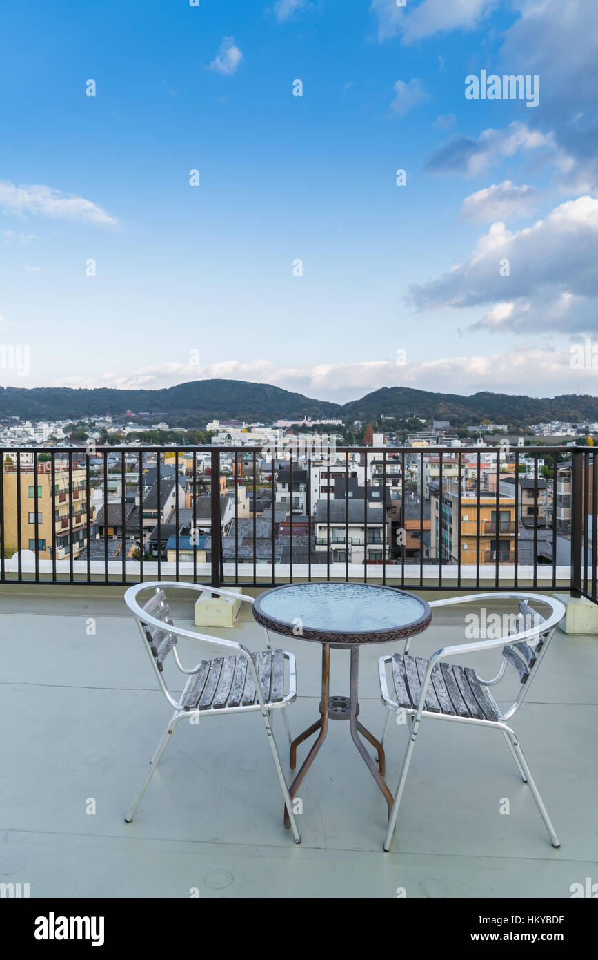 Table and chairs on roof top terrace exterior Stock Photo - Alamy