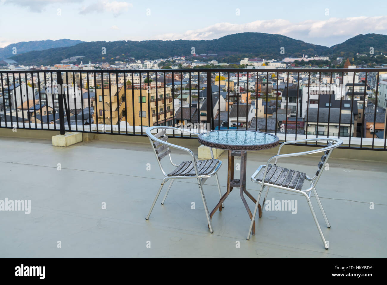 Table and chairs on roof top terrace exterior Stock Photo - Alamy