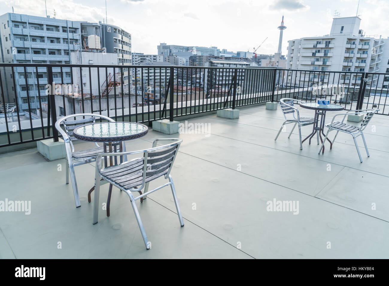 Table and chairs on roof top terrace exterior Stock Photo - Alamy