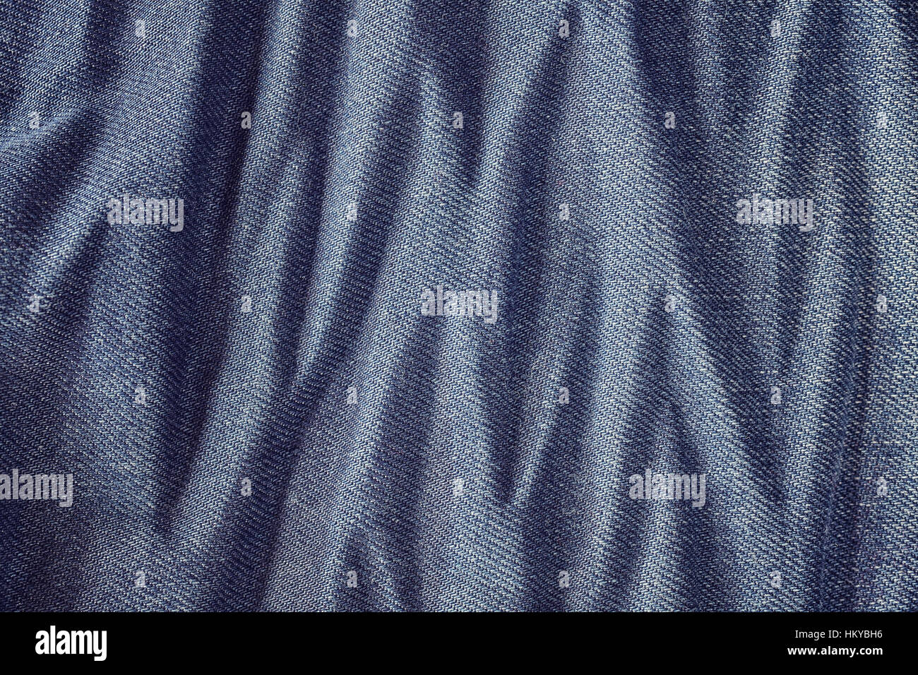 Close up picture of wrinkly blue jeans fabric background or texture ...