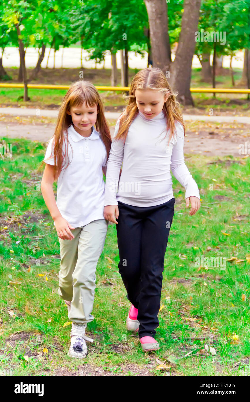 Photo of two walking girls in summer Stock Photo - Alamy