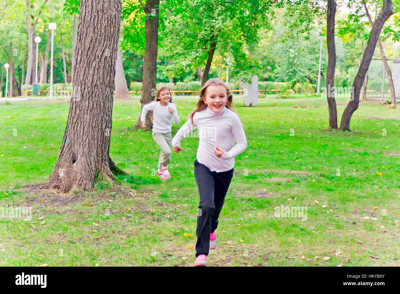 Two girls running hi-res stock photography and images - Alamy