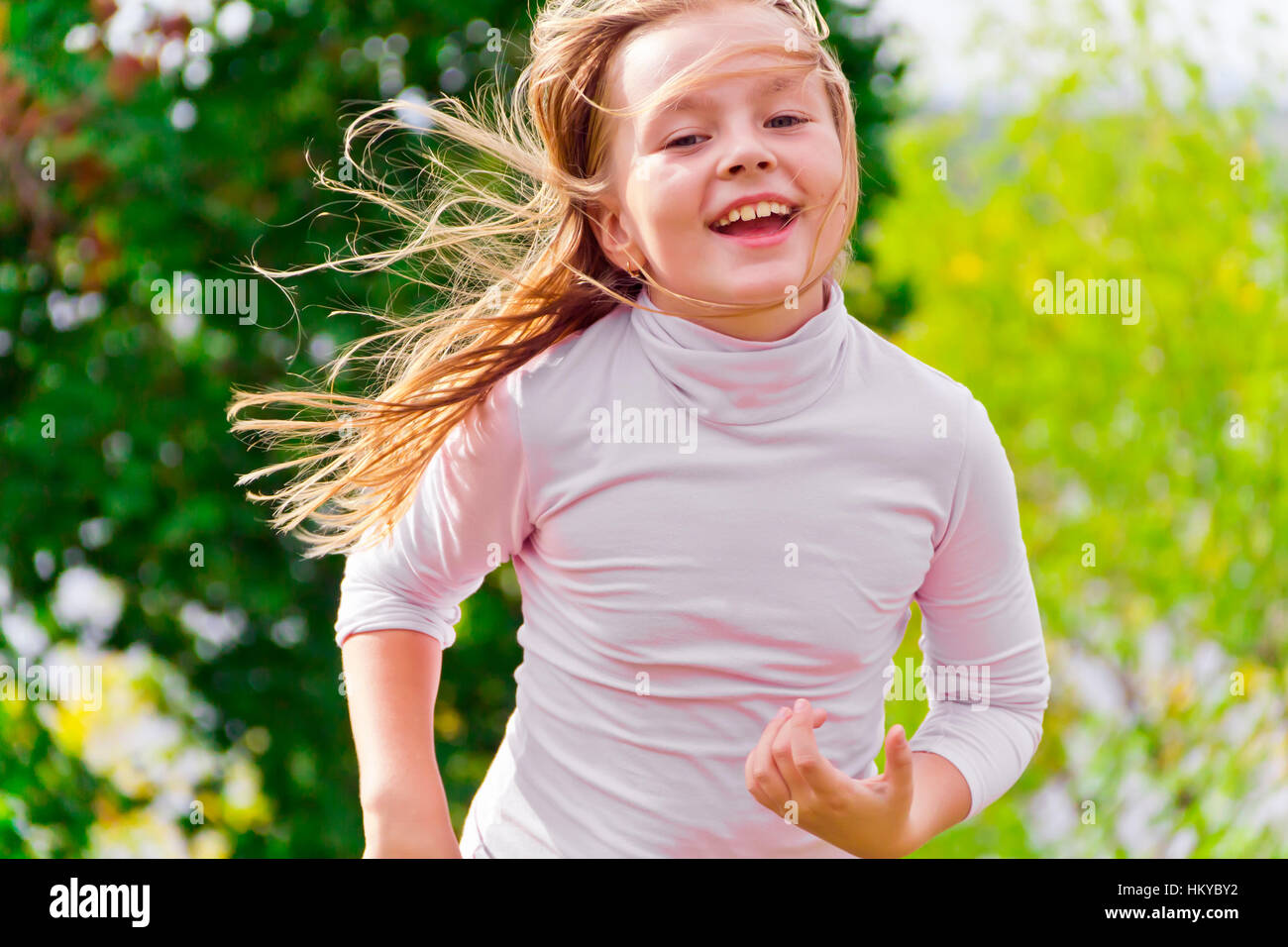 Photo of cute running girl in summer Stock Photo - Alamy