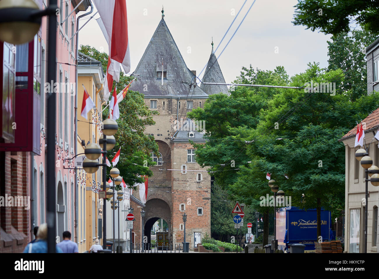 NEUSS, GERMANY - AUGUST 08, 2016: Pedestrants walk towards the historic ...