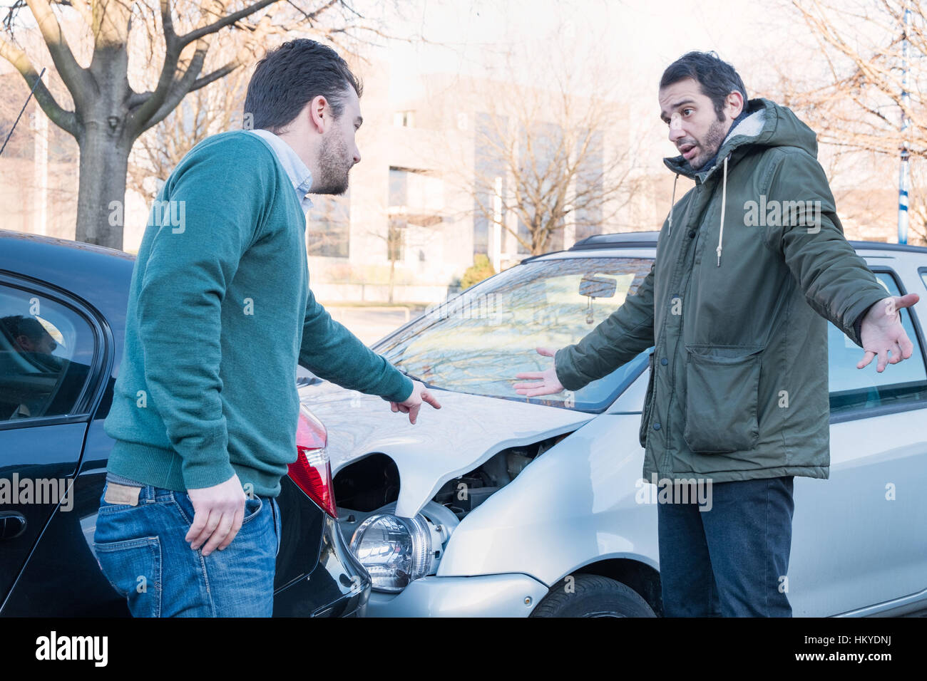 Two men arguing after a car crash accident Stock Photo - Alamy