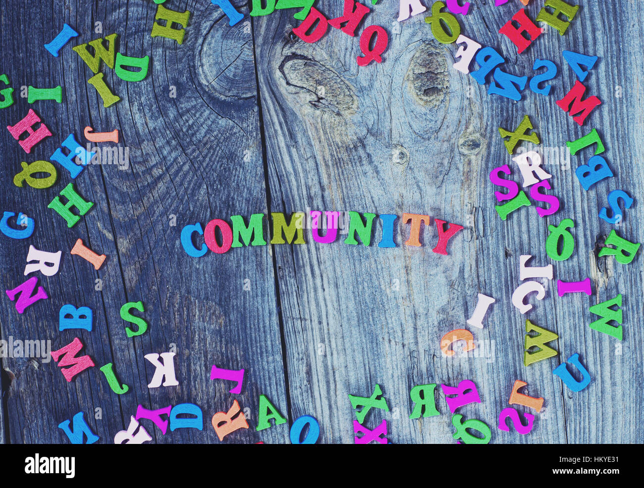 Colorful wooden letters on a gray old wooden background, in the middle ...