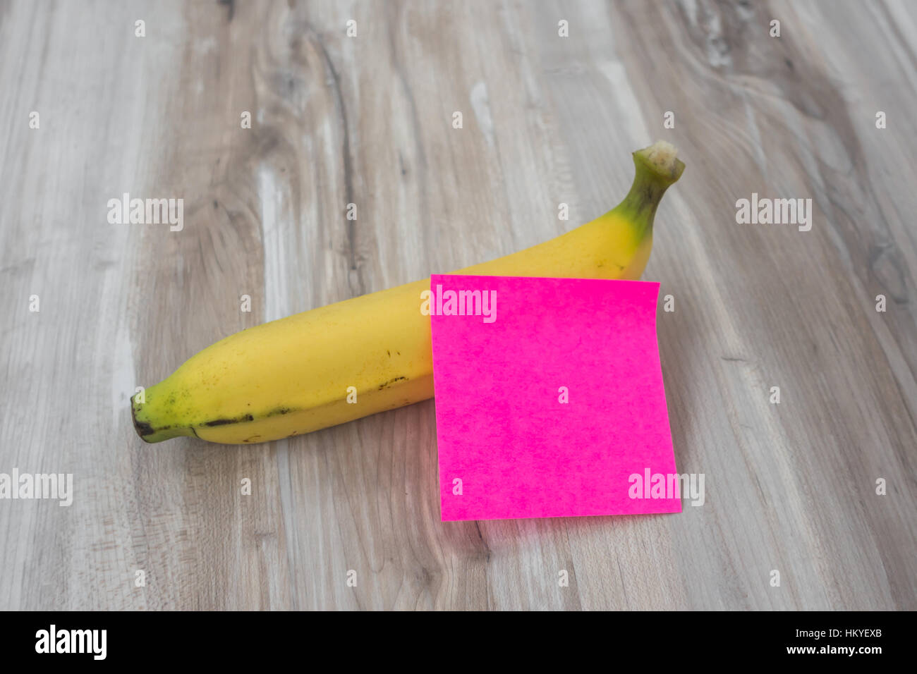 Banana with Sticky Note on wood table Stock Photo - Alamy