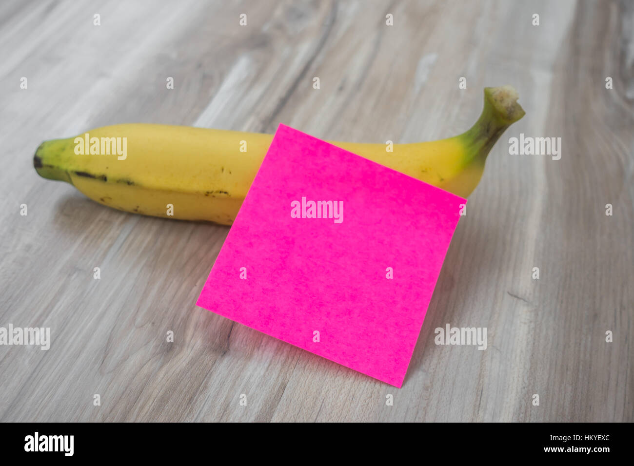 Banana with Sticky Note on wood table Stock Photo - Alamy