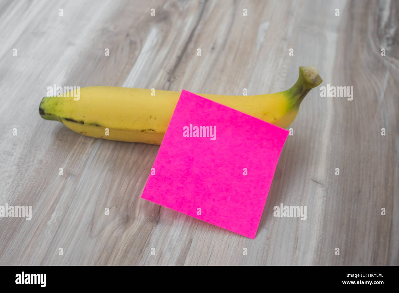 Banana with Sticky Note on wood table Stock Photo - Alamy