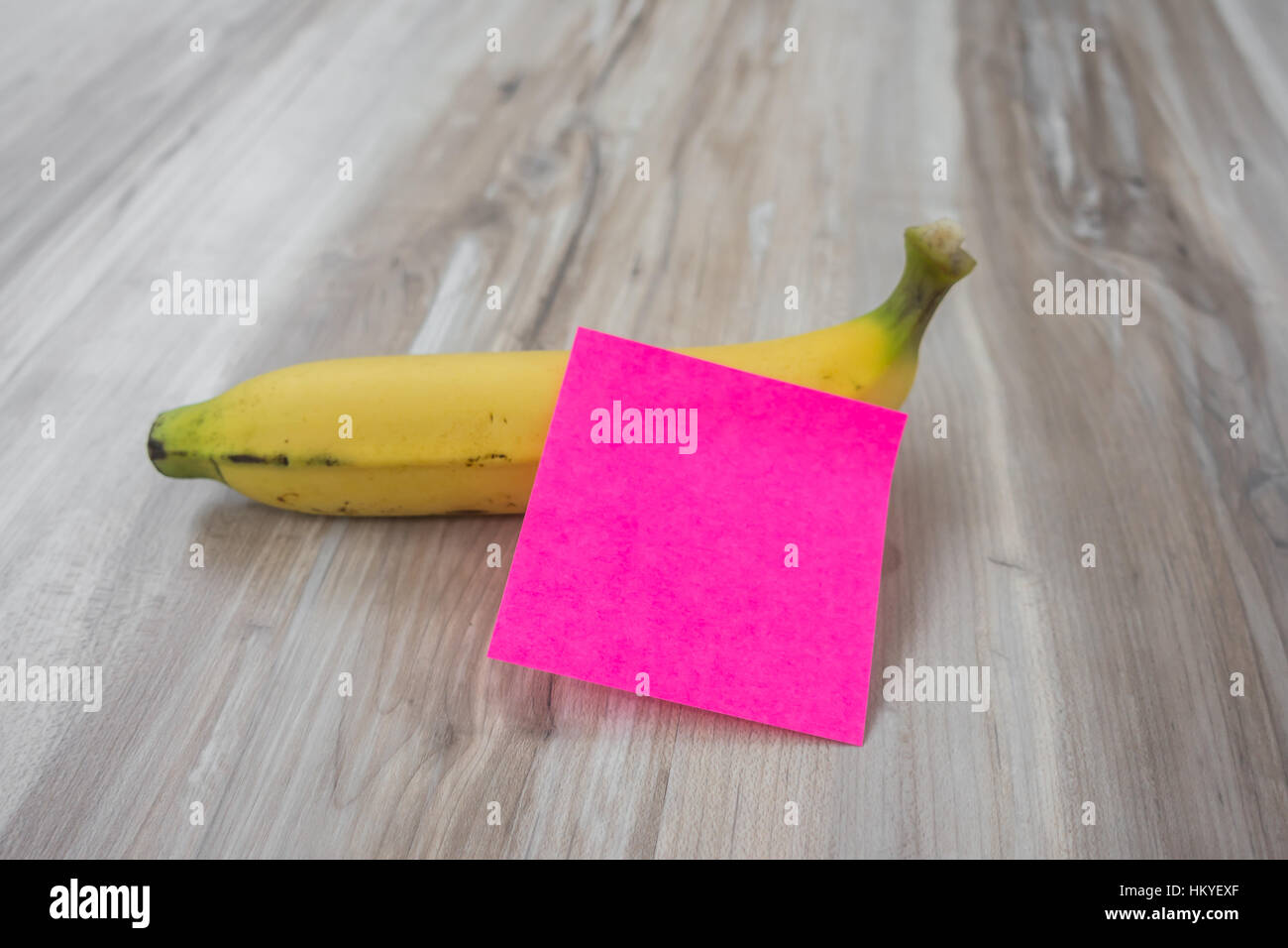 Banana with Sticky Note on wood table Stock Photo - Alamy