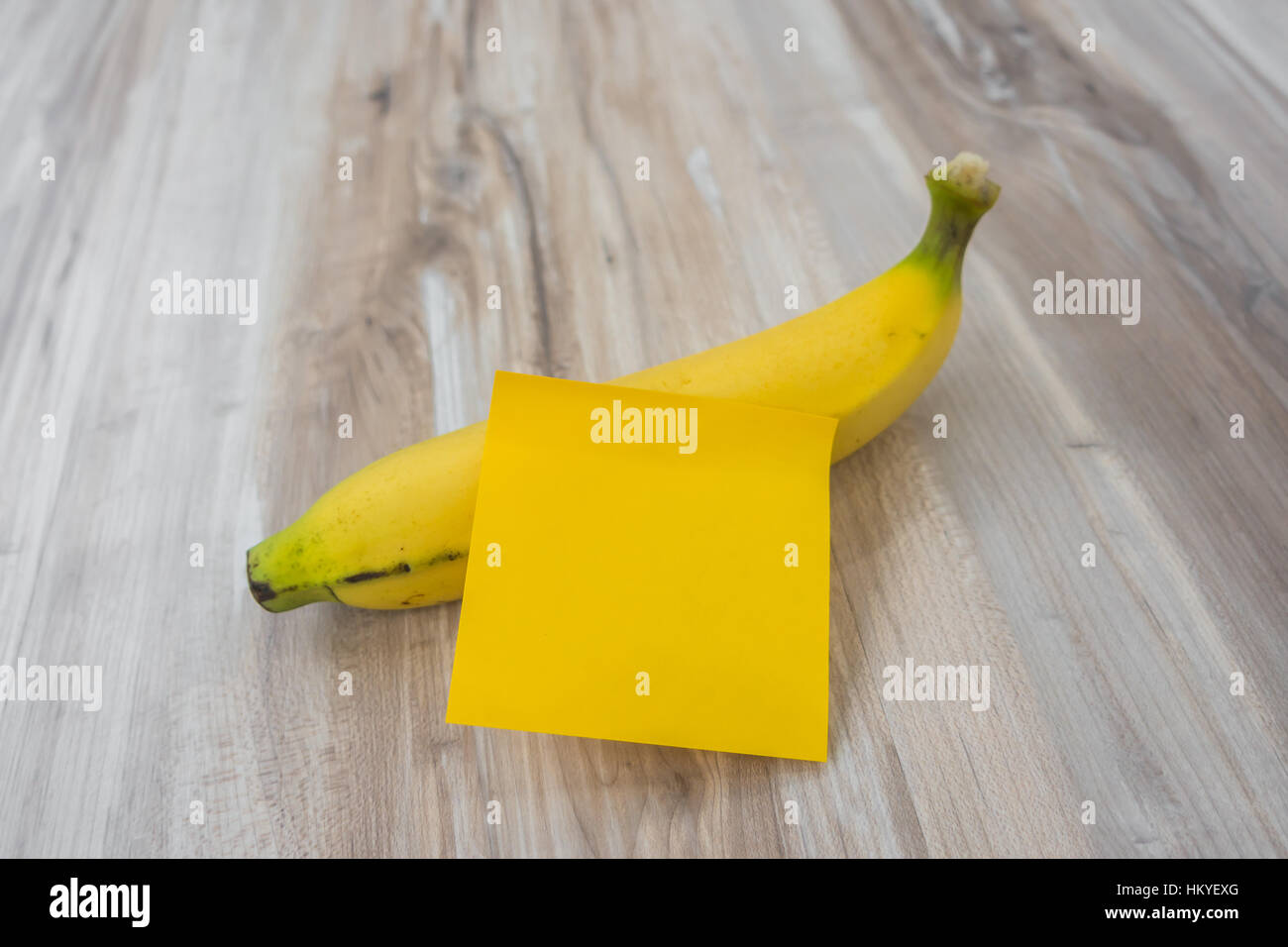Banana with Sticky Note on wood table Stock Photo - Alamy