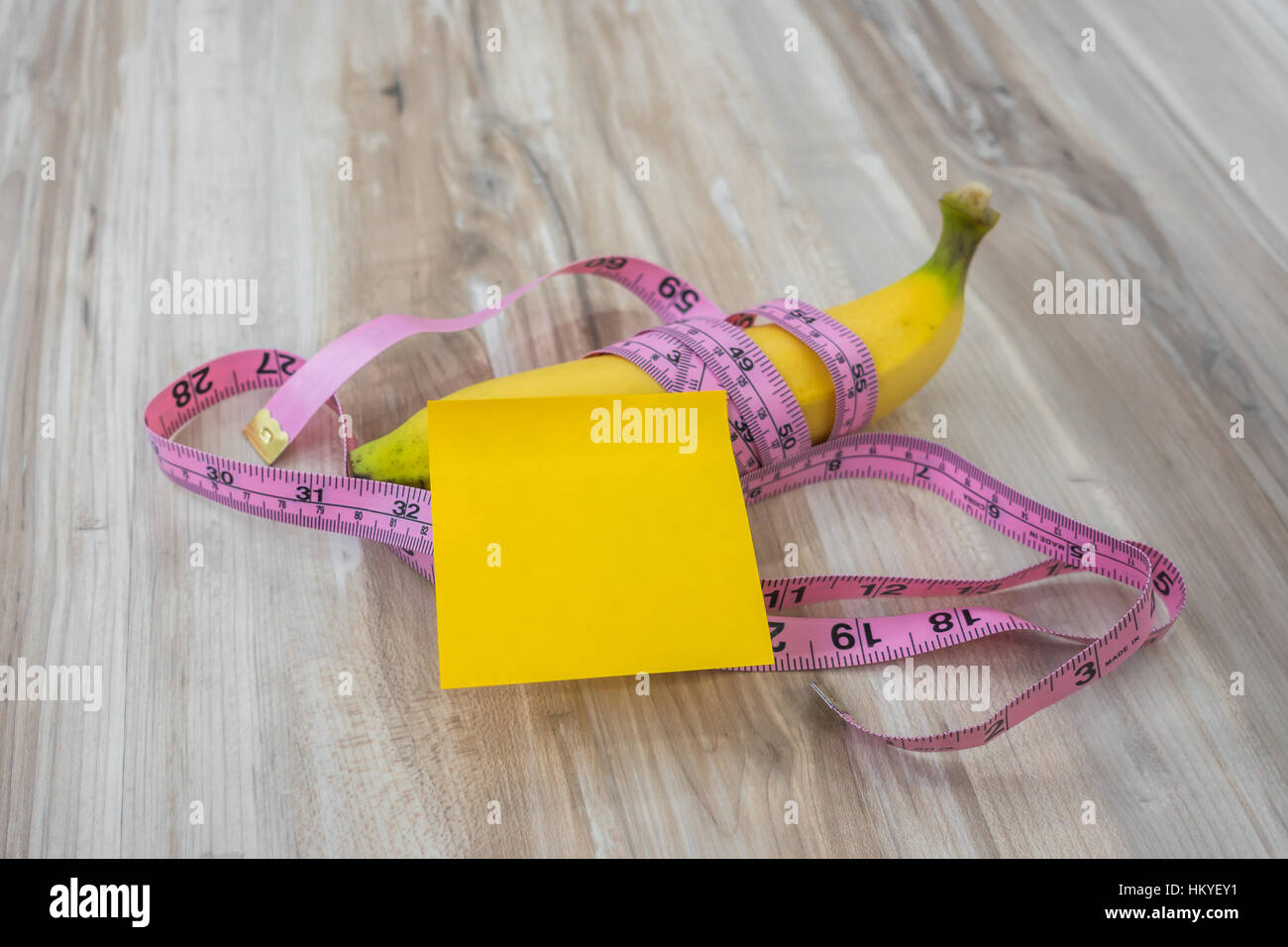 Banana with Sticky Note on wood table Stock Photo - Alamy