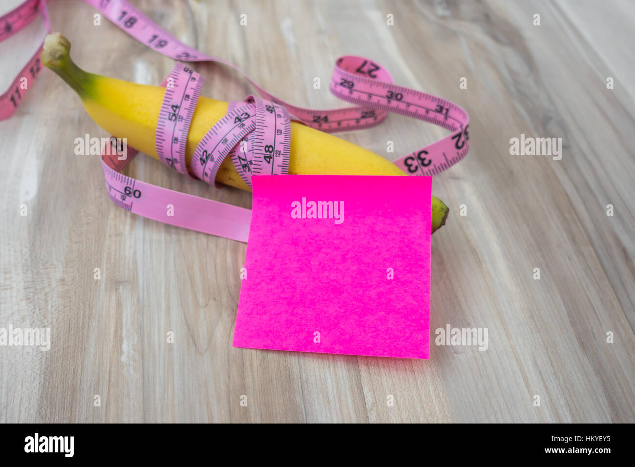 Banana with Sticky Note on wood table Stock Photo - Alamy