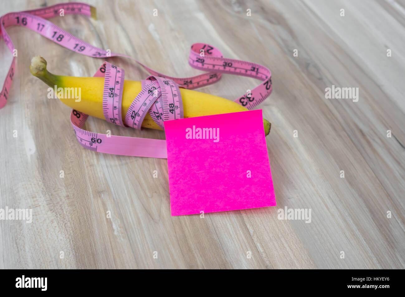 Banana with Sticky Note on wood table Stock Photo - Alamy