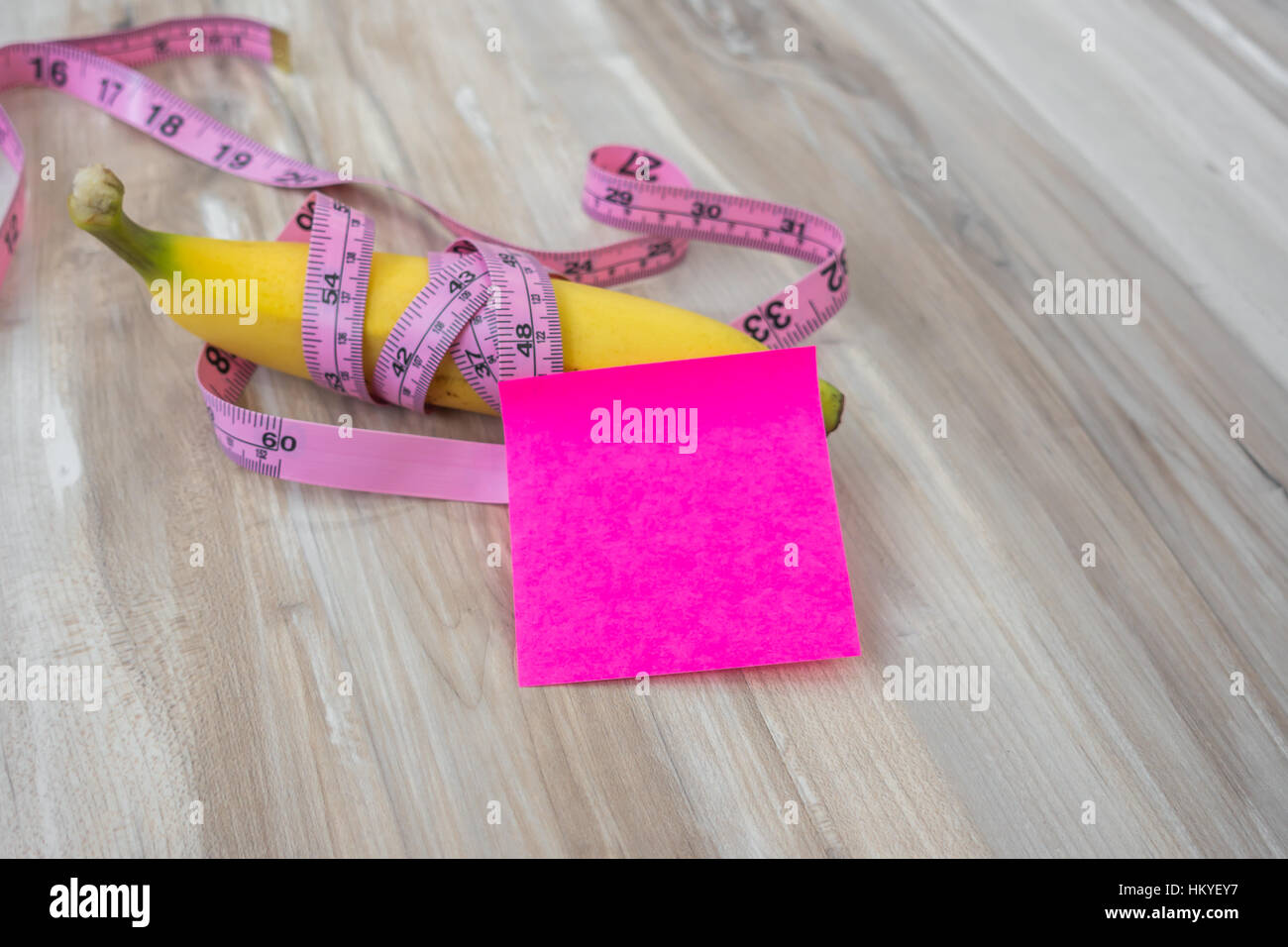 Banana with Sticky Note on wood table Stock Photo - Alamy