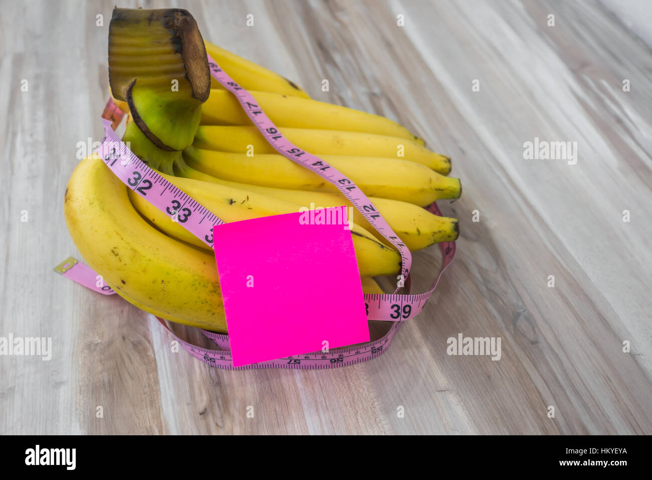 Banana with Sticky Note on wood table Stock Photo - Alamy