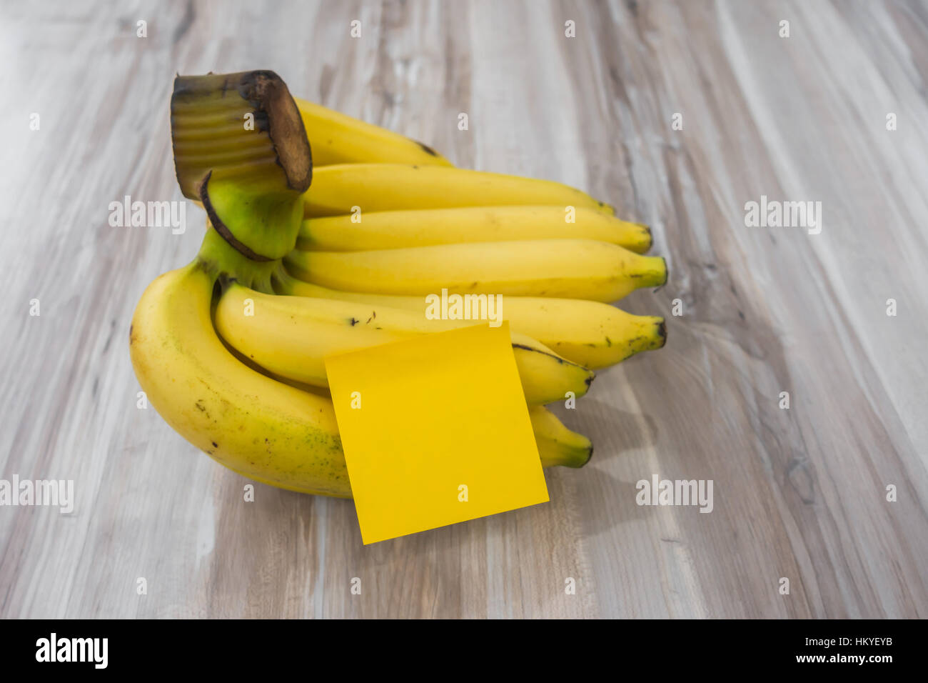 Banana with Sticky Note on wood table Stock Photo - Alamy