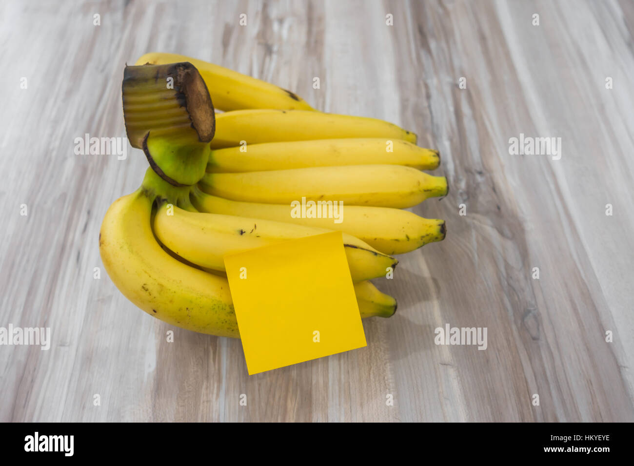 Banana with Sticky Note on wood table Stock Photo - Alamy