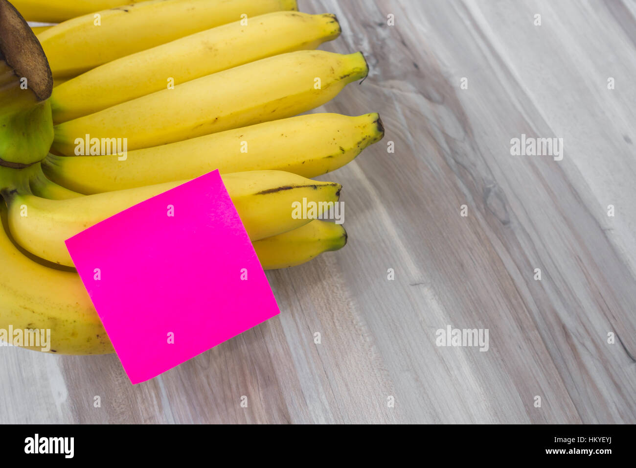 Banana with Sticky Note on wood table Stock Photo - Alamy